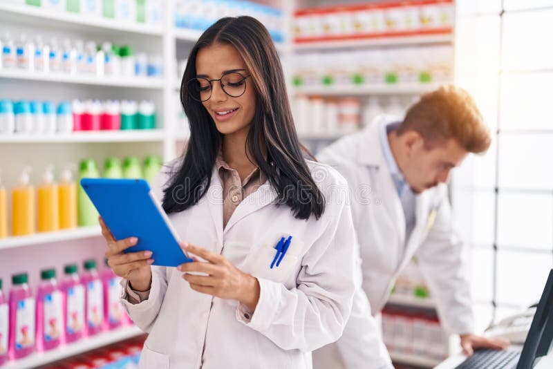 Man and Woman Pharmacists Using Touchpad and Computer Working at ...