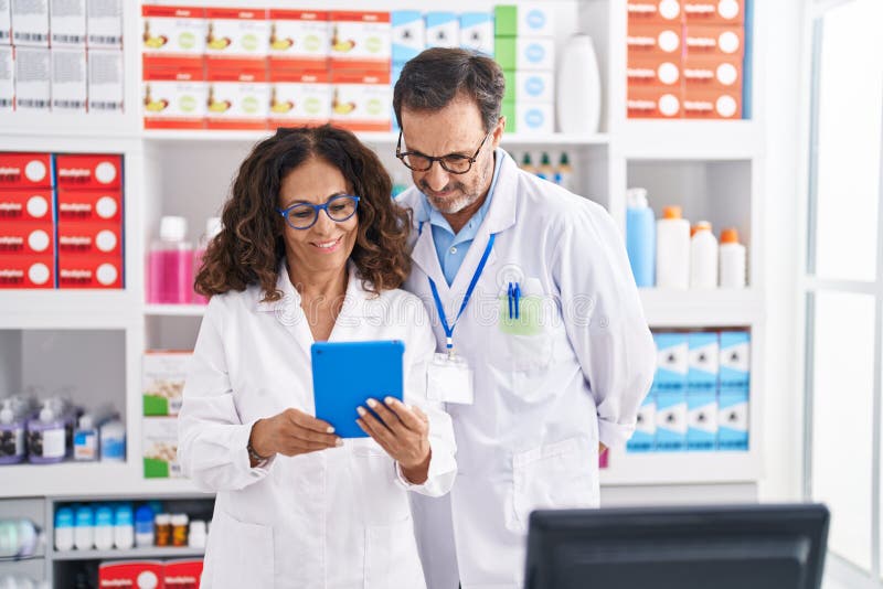 Man and Woman Pharmacists Using Touchpad Working at Pharmacy Stock ...