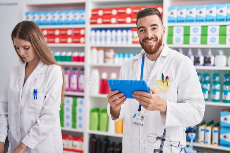 Man and Woman Pharmacists Using Touchpad Working at Pharmacy Stock ...