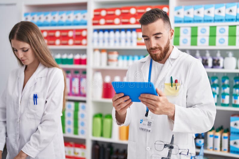 Man and Woman Pharmacists Using Touchpad Working at Pharmacy Stock Image - Image of prescription ...