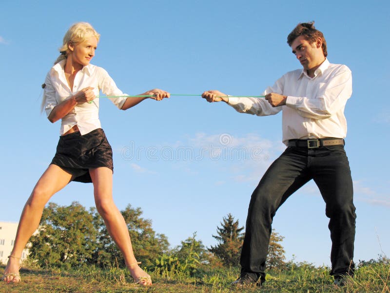 Man and woman pull a rope stock photo. Image of career - 3085376