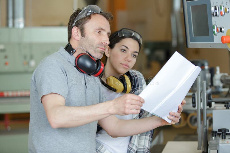 Man Woman Reading Paperwork Using Machine Stock Photos - Free & Royalty ...
