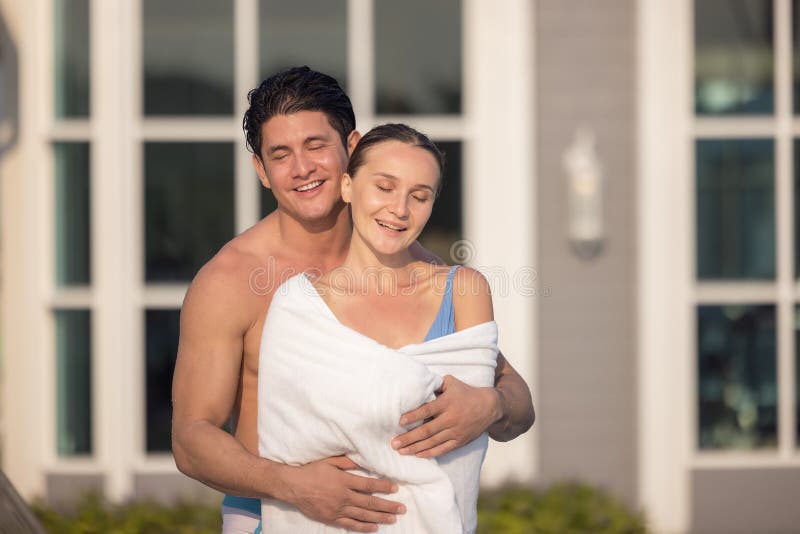 Man and Woman Relaxing on Infinity Pool Deck in Swimsuits Stock Photo ...