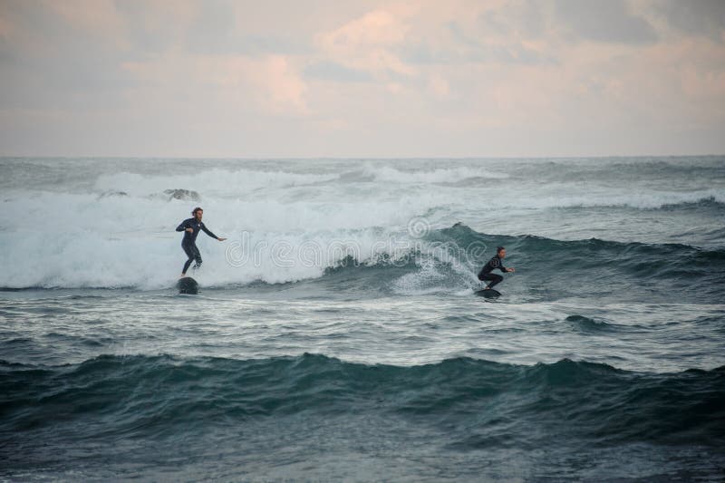 Man and Woman Riding Waves on Surfboard Stock Photo - Image of ride ...