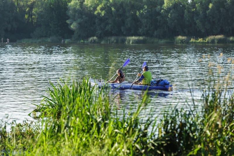 Man and Woman Rowing Oars in the Canoe on the River Editorial Stock ...