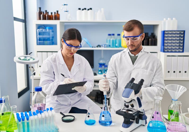 Man and Woman Scientist Partners Working at Laboratory Stock Photo ...