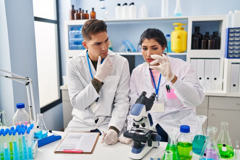 Man and Woman Scientists Partners Analysing Sample at Laboratory Stock ...