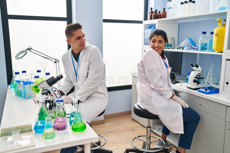 Man and Woman Scientists Partners Using Microscope Working at ...