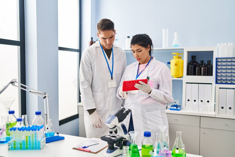 Man and Woman Scientists Partners Using Touchpad at Laboratory Stock ...
