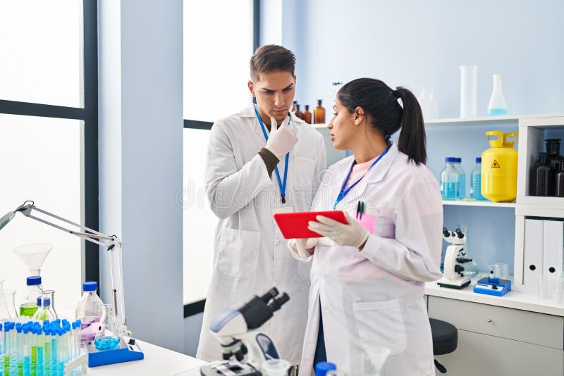 Man and Woman Scientists Partners Using Touchpad at Laboratory Stock ...