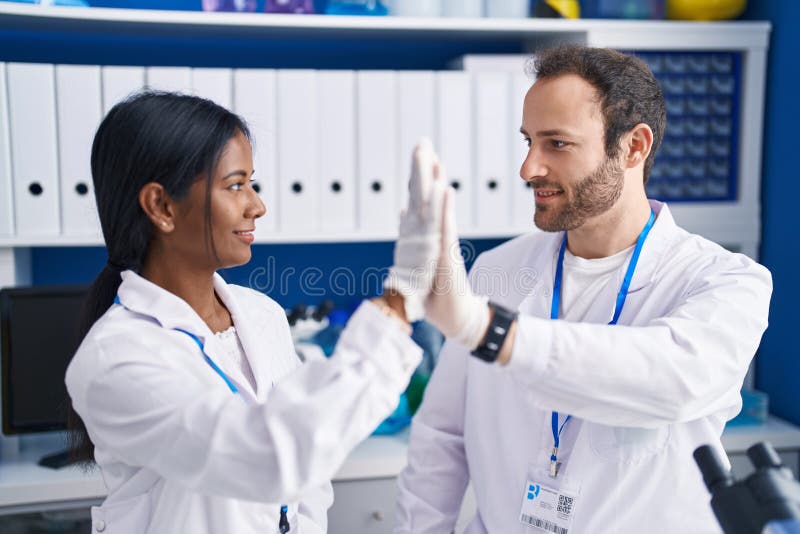 Man and Woman Scientists Smiling Confident High Five at Laboratory ...