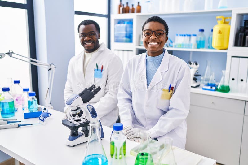 Man and Woman Scientists Smiling Confident at Laboratory Stock Photo ...