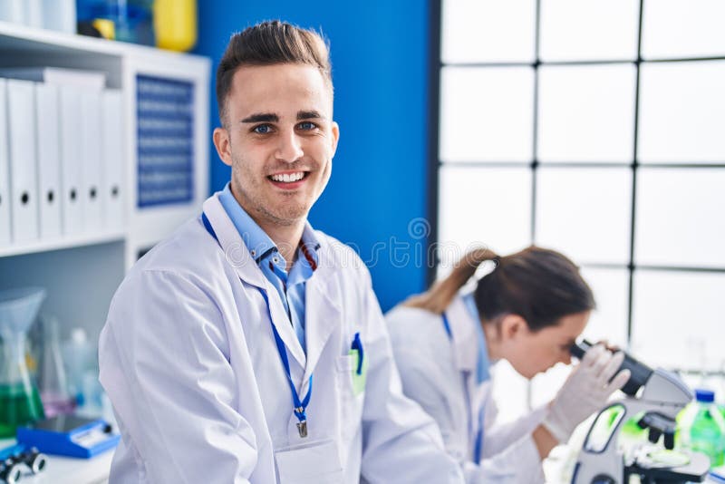 Man and Woman Scientists Smiling Confident Microscope at Laboratory ...