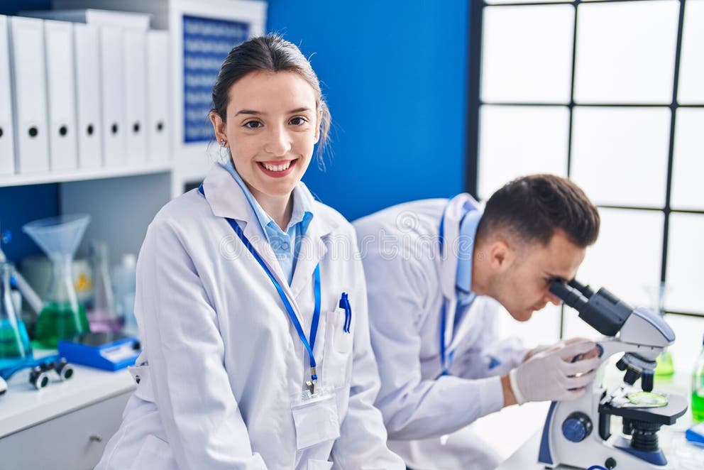 Man and Woman Scientists Smiling Confident Microscope at Laboratory ...