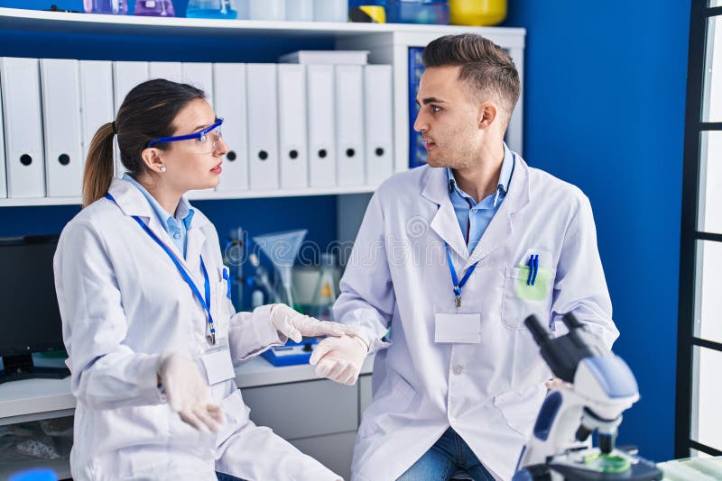Woman and Man Scientists in Lab Coat Making Notes after Doing Sample ...