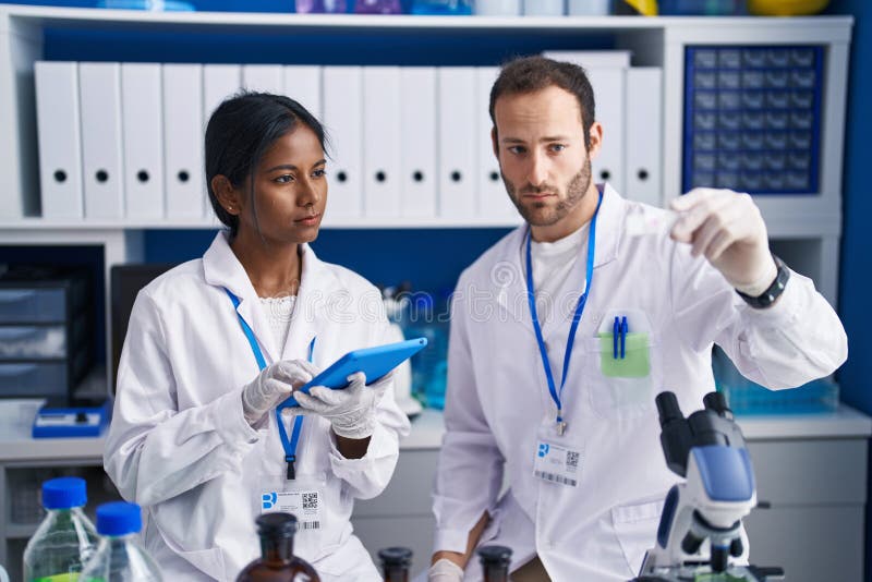 Man and Woman Scientists Using Touchpad Holding Sample at Laboratory ...