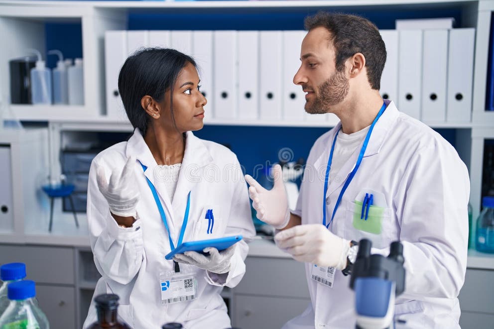 Man and Woman Scientists Using Touchpad Holding Sample at Laboratory ...