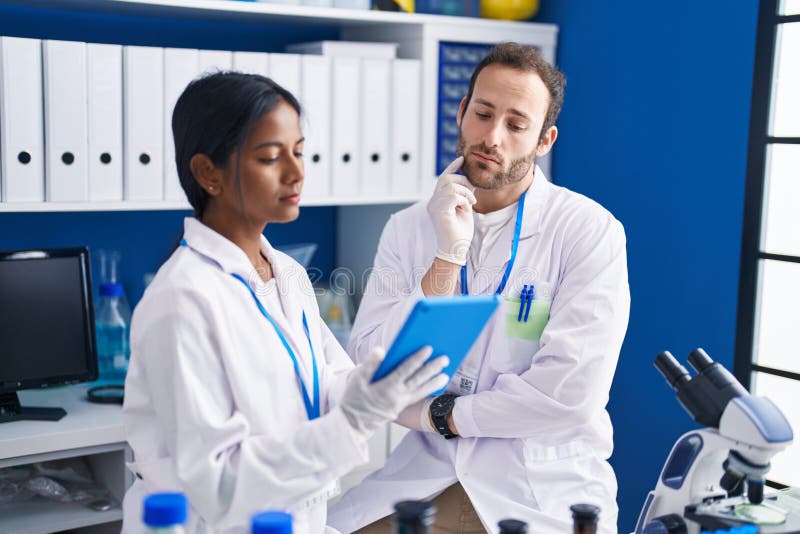 Man and Woman Scientists Using Touchpad Working at Laboratory Stock ...