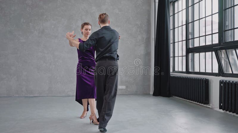 Man and Woman are Sensually Doing Tango Pose in Grey Studio Stock ...