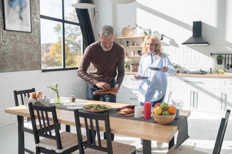 Man and Woman Serving the Table for Dinner Stock Photo - Image of ...
