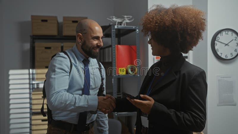 Man and Woman Shaking Hands in a Modern Office Setting, Conveying ...