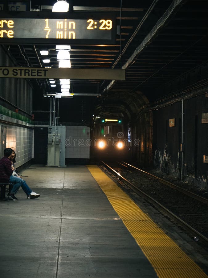 Man and a Woman Sitting and Talking on a Bench in a Subway with ...