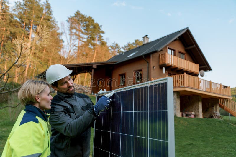 Man and Woman Solar Installers Carrying Solar Module while Installing ...