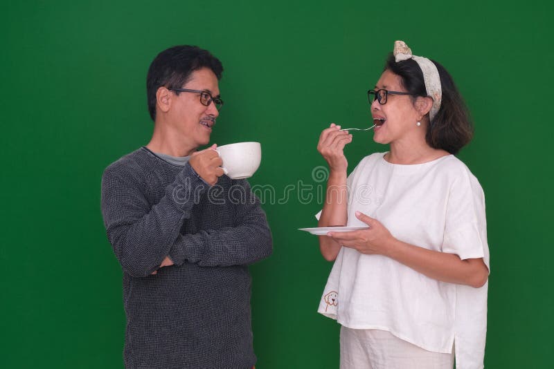 Man and Woman Standing and Enjoying Some Snacks and Evening Tea Stock ...