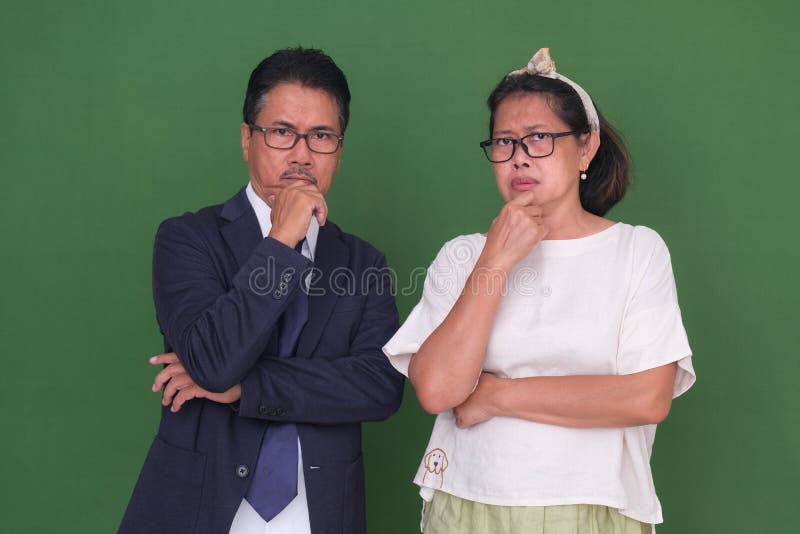 Man and Woman Standing and Seriously Observing Something with Serious ...