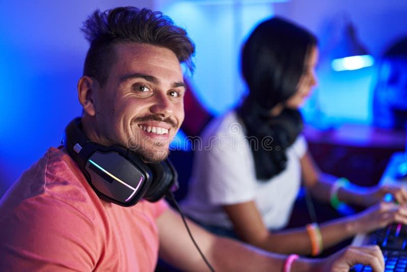 Man and Woman Streamers Playing Video Game Using Computer at Gaming ...