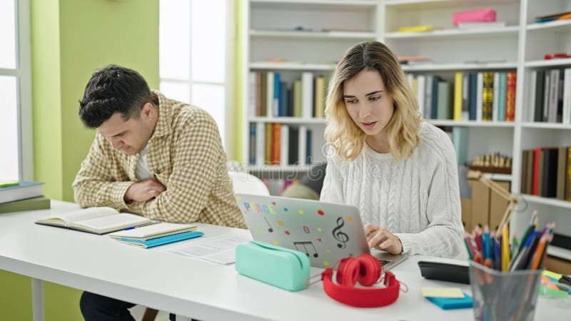 Man and Woman Students Using Laptop Reading Book at Library University ...