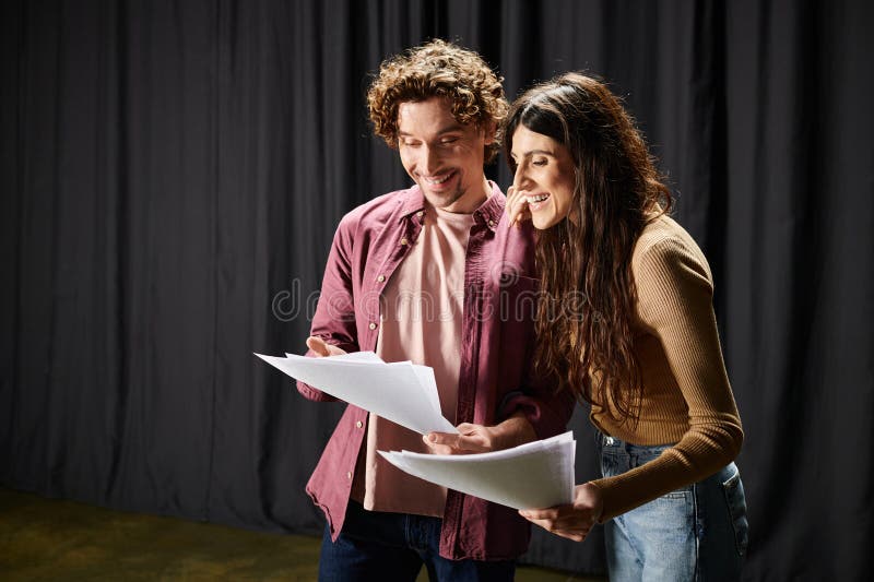A Man and Woman Study a Script Together, Deeply Engaged Stock Photo ...