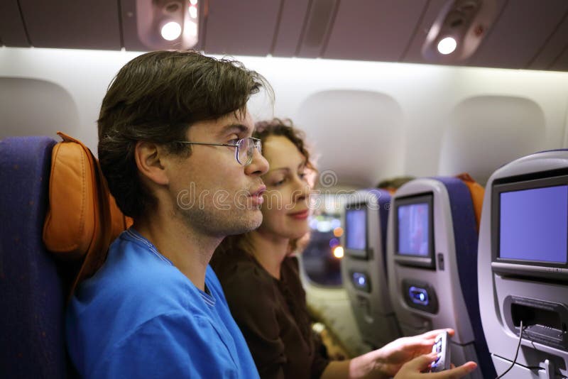 Man and Woman Switch Channels on Display on Seat Stock Image - Image of ...