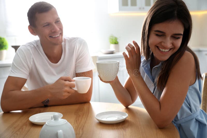 Man and Woman Talking while Drinking Tea at Table in Kitchen Stock ...