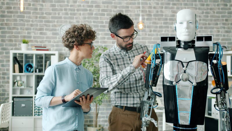 Man and Woman Testing Modern Human-like Robot in Laboratory Using ...