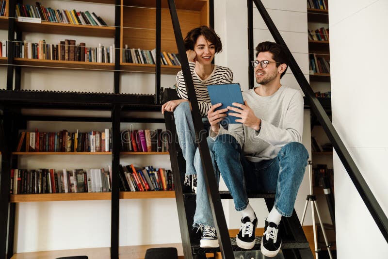 Man and Woman Using Tablet while Studying in Library Stock Image ...