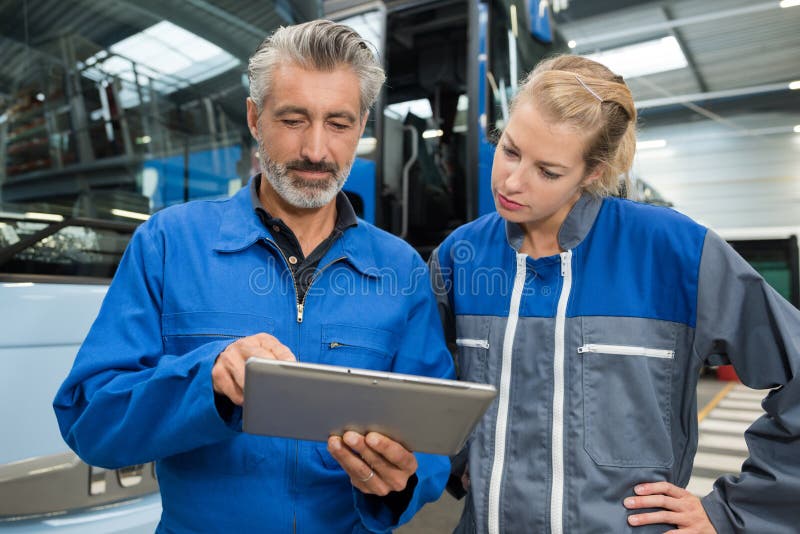 Man and Woman Using Tablet To Fix Car Stock Photo - Image of dealer ...