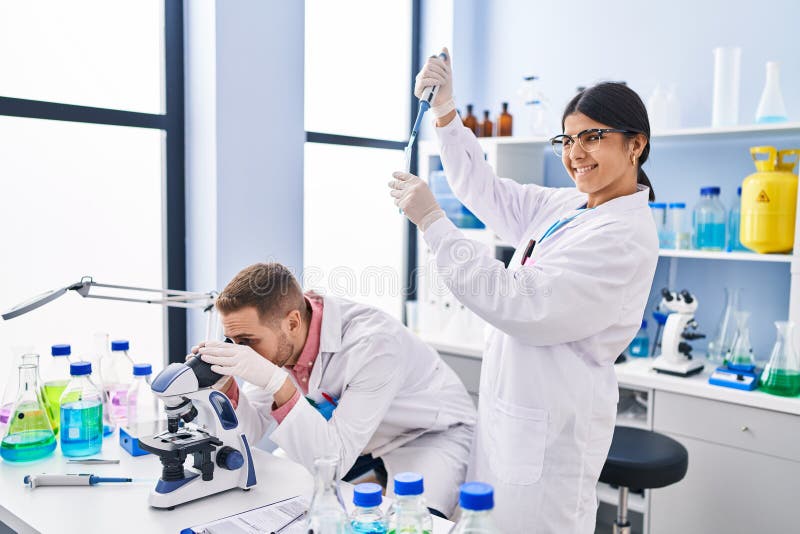 Man and Woman Wearing Scientists Uniform Working at Laboratory Stock ...