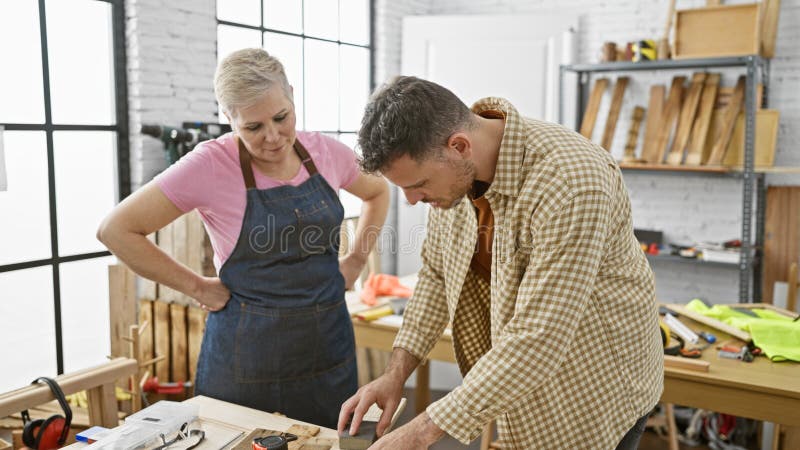 A Man and Woman Work Together in a Carpentry Workshop Surrounded by ...