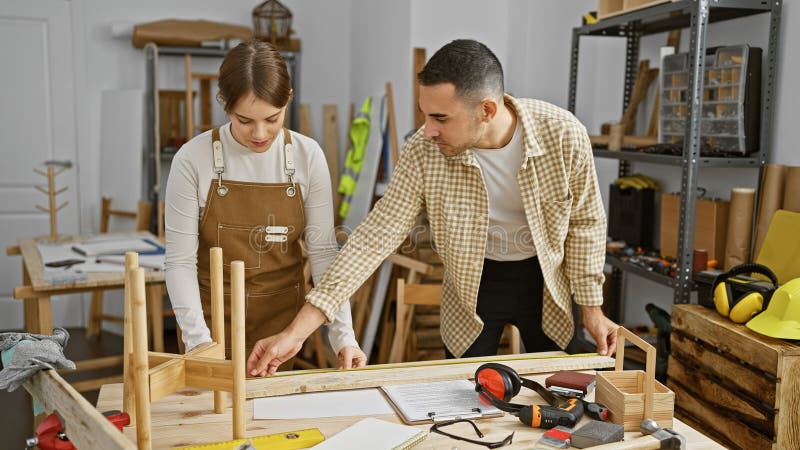 A Man and Woman Work Together in a Well-equipped Carpentry Workshop ...