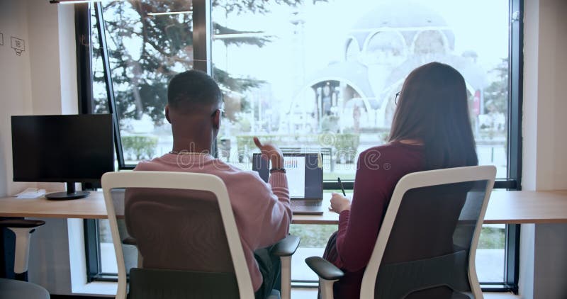 Man and Woman Working Side by Side at an Office with a View Looking ...