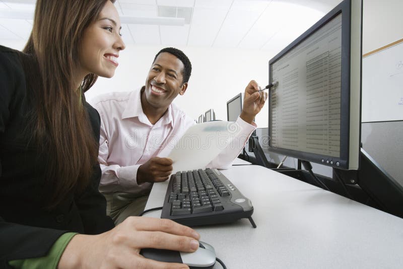 Man and Woman Working Together in Computer Lab Stock Image - Image of ...