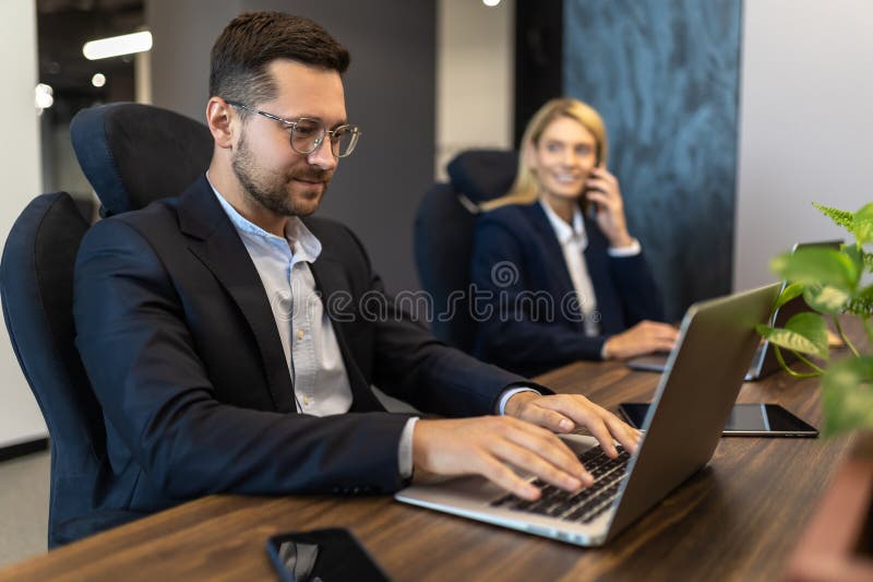 Man and Woman Working Together on Digital Project Using Modern ...