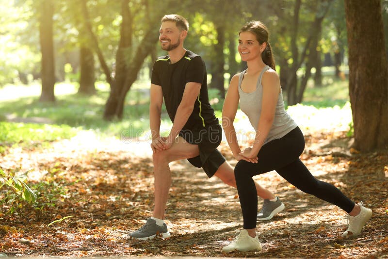 Man and Woman Doing Morning Exercise in Park Stock Photo - Image of ...