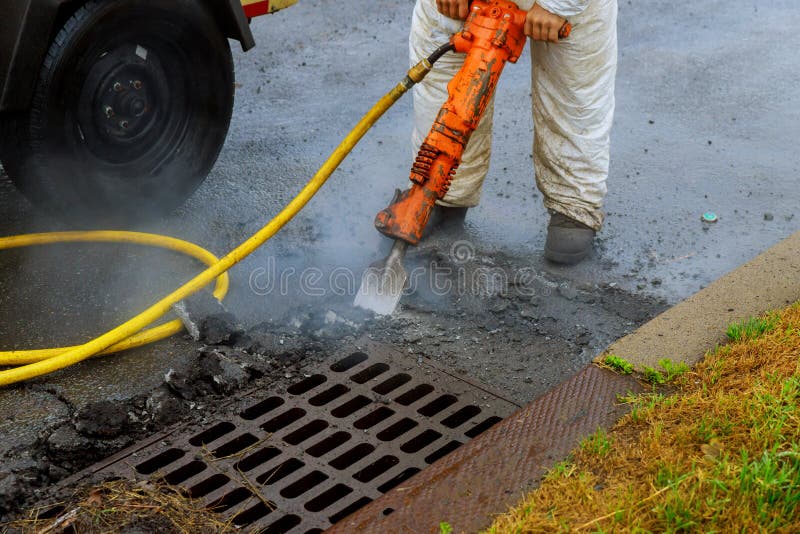Breaking out asphalt stock image. Image of digger, crushing - 163698683