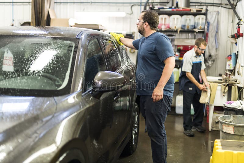 Man at Work Cleaning Automobile at Car Wash Stock Photo - Image of ...