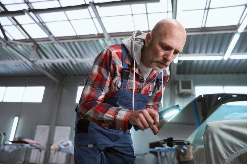 Man in Work Clothes Works with a Car Detail Stock Photo - Image of ...