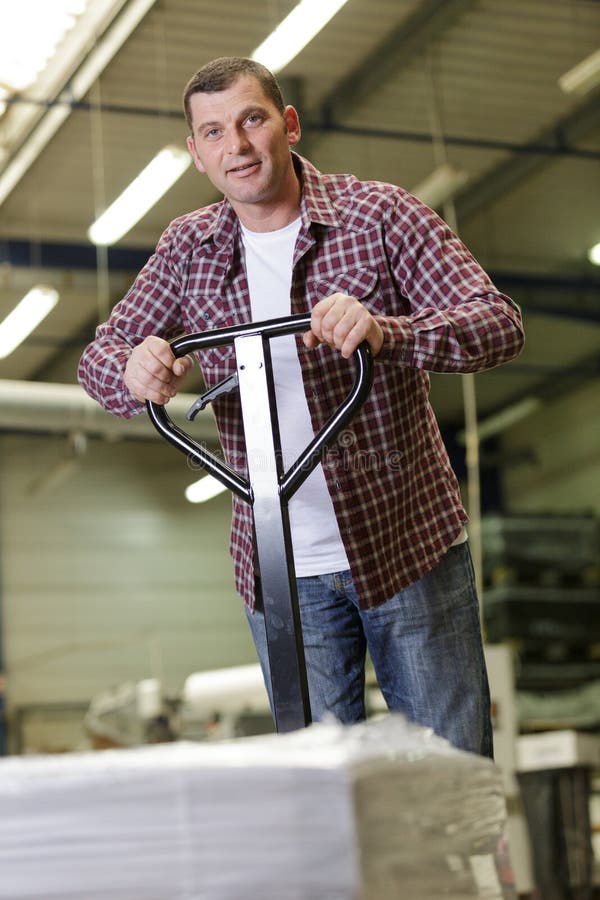 Man Work on Fork Lifter with Pallet in Warehouse Stock Photo - Image of ...