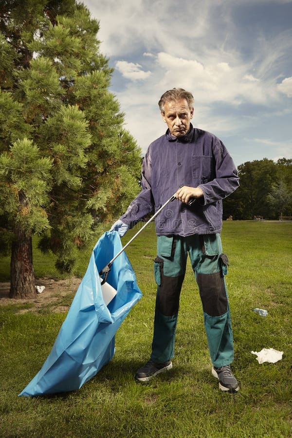 Man at Work Pick Up Garbage on Grass in Park Stock Photo - Image of ...