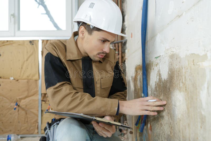 Man worker checks wall stock photo. Image of builder - 174507102